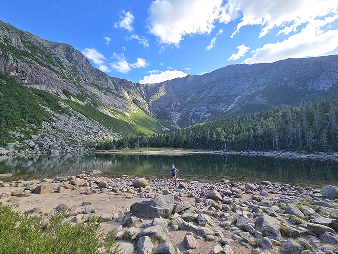 The mountain basin cradles crystal waters like a giant's cupped hands, reflecting the majesty of Maine's highest peak.