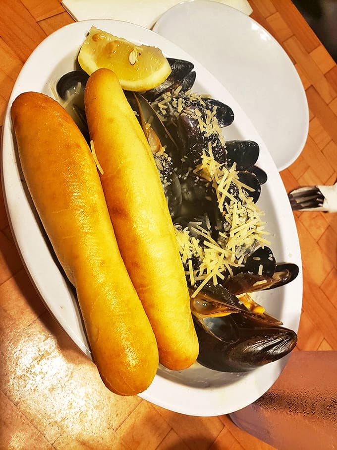 Steamed mussels with garlic bread for sopping &ndash; a Mediterranean moment on Lake Erie's shores that proves great seafood knows no boundaries.