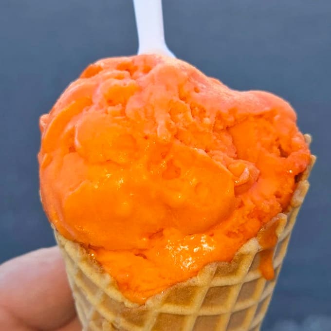 Tangerine dreams in cone form &ndash; this electric orange scoop practically vibrates with flavor, demanding to be photographed before it's devoured.