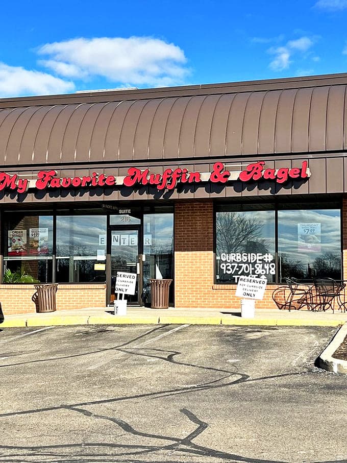 The exterior view reveals the red cursive sign that locals have come to recognize as a beacon of bagel excellence.