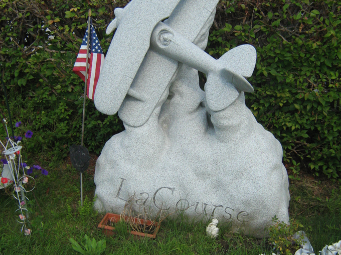 This striking airplane monument soars toward the heavens, commemorating a pilot's life with the perfect symbol of freedom and flight.