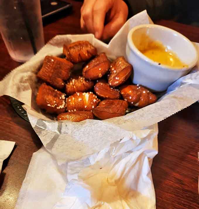 Warm pretzel bites dusted with salt arrive with a side of melted butter &ndash; simple perfection that disappears all too quickly.
