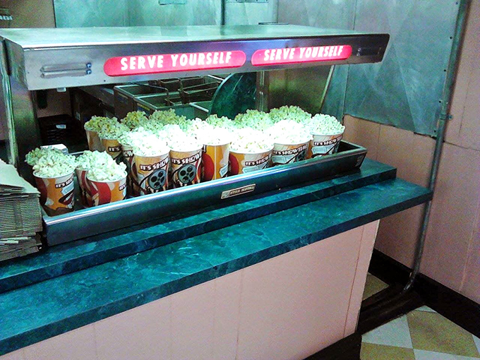Self-serve popcorn stations ensure no movie fan goes hungry, with those signature cardboard buckets ready for filling.