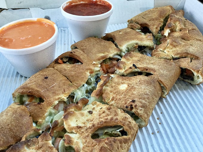The stromboli: where pizza ingredients go for their spa retreat, emerging transformed into a spiral of flavor that demands to be savored slowly.