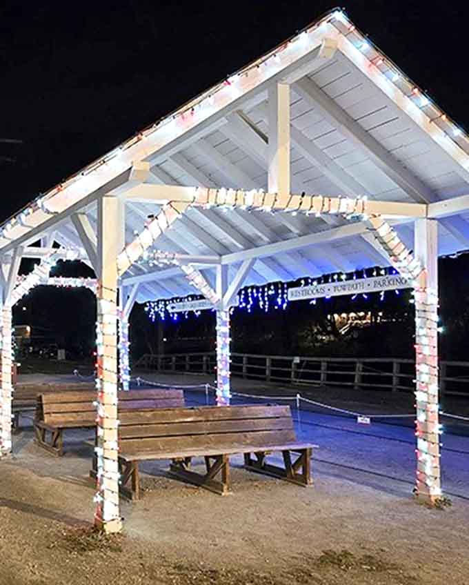 Peninsula's charming station platform glows with holiday lights, creating a magical departure point for evening excursions through the national park.