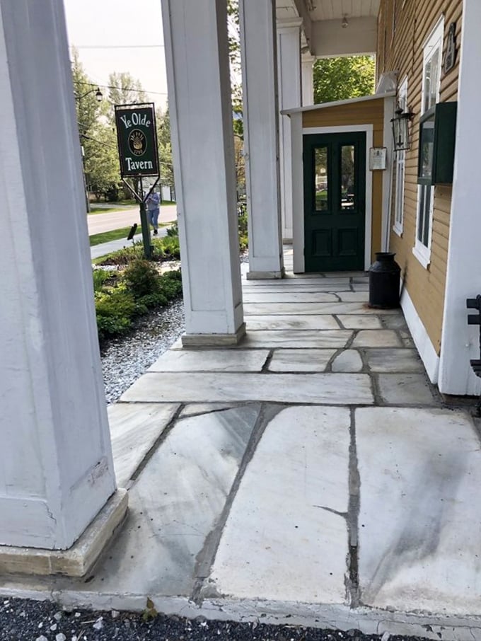 Stone pathways lead to culinary treasures &ndash; the entrance to Ye Olde Tavern promises a dining experience steeped in history and flavor.