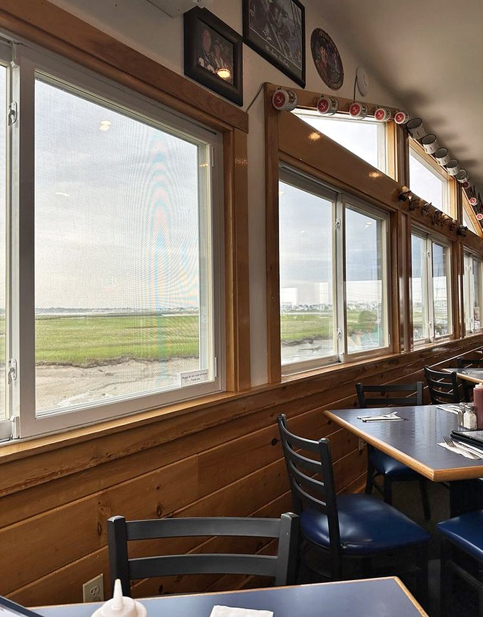 Those windows frame the coastal marsh like living paintings, offering diners nature's show while they savor the catch of the day.