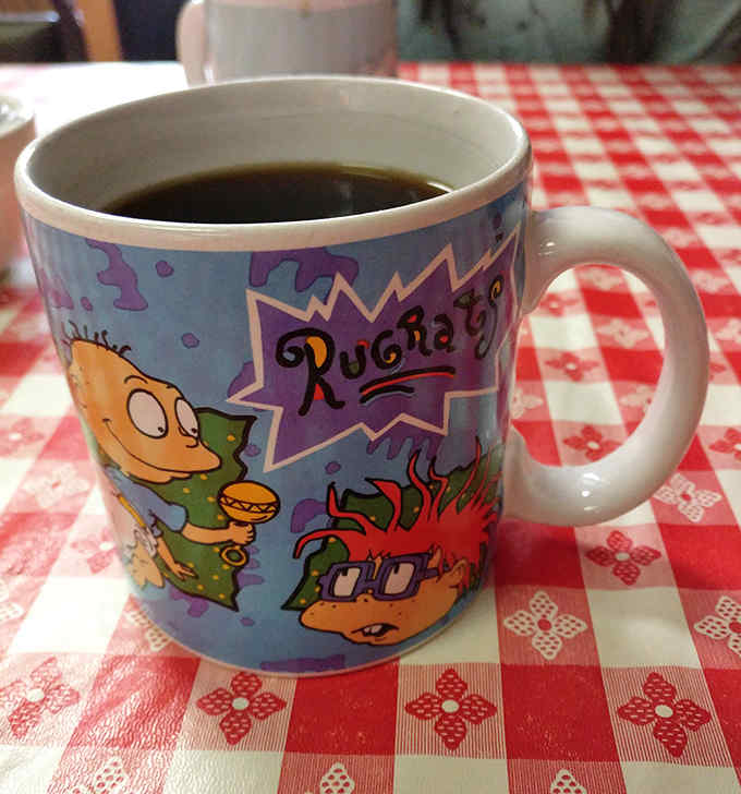 Morning philosophy served in a nostalgic Rugrats mug &ndash; because great diner coffee tastes even better with a side of childhood memories.