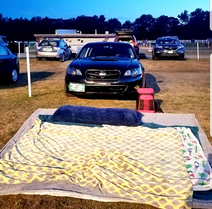 The back of a pickup truck transforms into the coziest living room imaginable, complete with blankets, pillows, and starry skies.