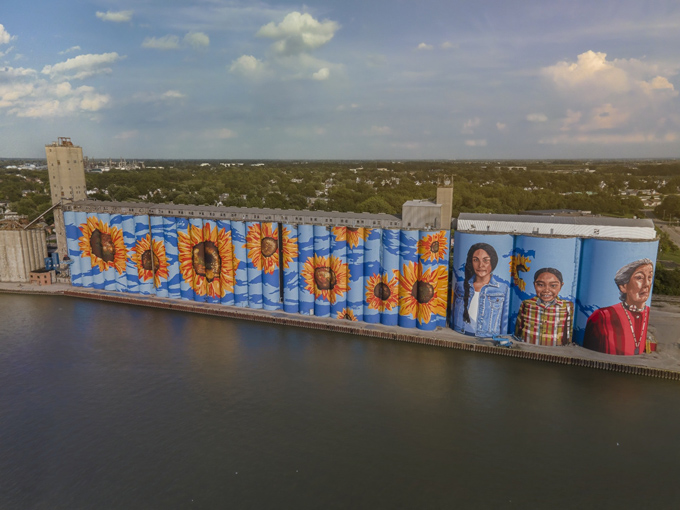 A stunning mural of sunflowers and local faces stretches across the waterfront, celebrating culture, color, and Toledo&rsquo;s creative community spirit.