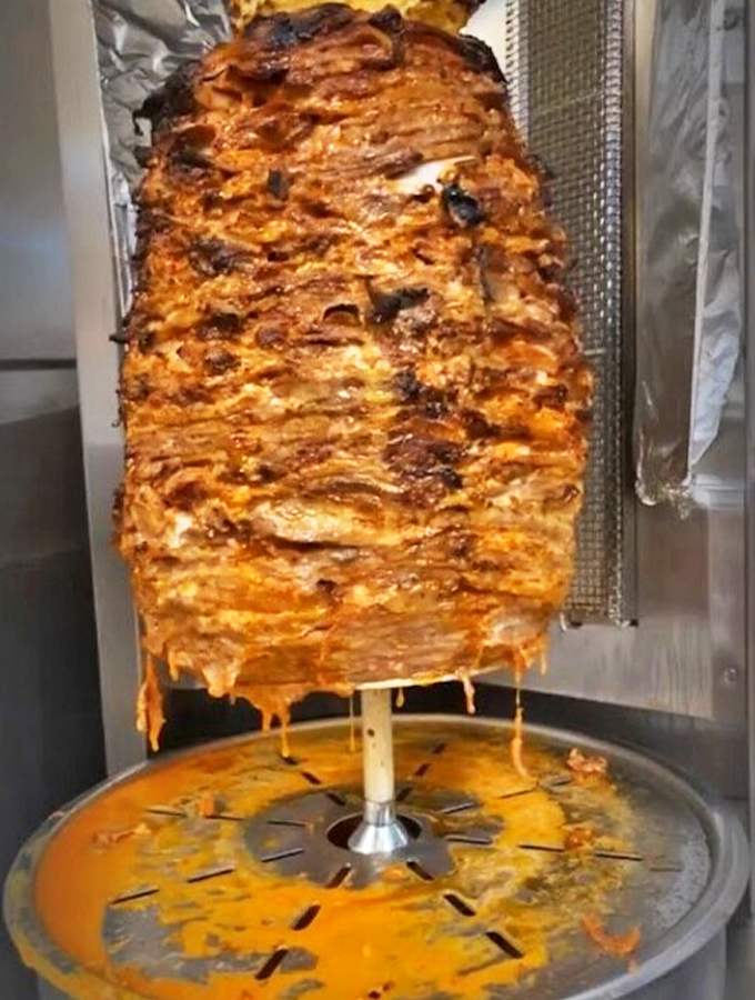 The trompo in action&mdash;a mesmerizing display of marinated pork that's part culinary art, part flavor engineering.