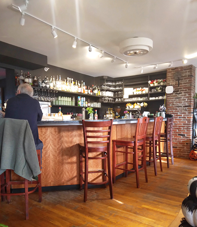 The well-stocked bar area offers a cozy spot to unwind with a local brew after exploring Putney's countryside.