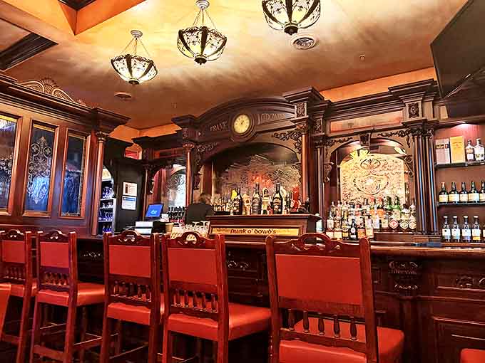 The bar area showcases impressive craftsmanship with intricate woodwork and an array of spirits that would make any whiskey enthusiast weak at the knees.
