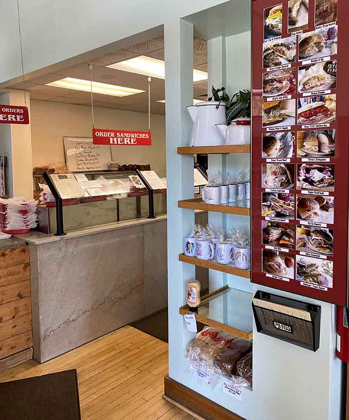 Those shelves hold the essentials for a proper deli experience, from beverages to condiments to local products worth discovering.