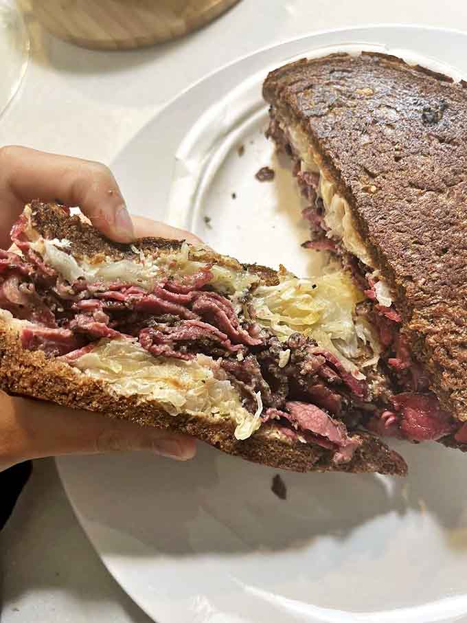 Brooklyn meets Michigan in this rye-hugged masterpiece where pastrami and corned beef coexist in perfect harmony beneath a blanket of melted Swiss.