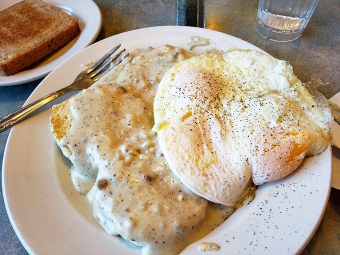 Southern comfort meets Midwest charm. Flaky biscuits smothered in creamy gravy, with sunny-side-up eggs for good measure. Pure breakfast magic!