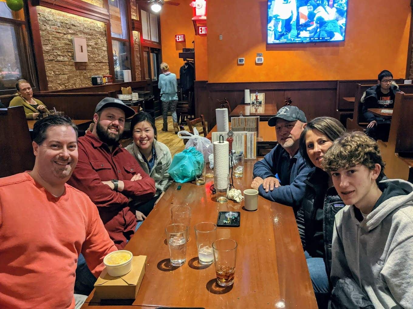 Happy diners gathered around the table, united by their love of great barbecue and those unforgettable sweet potato fries.