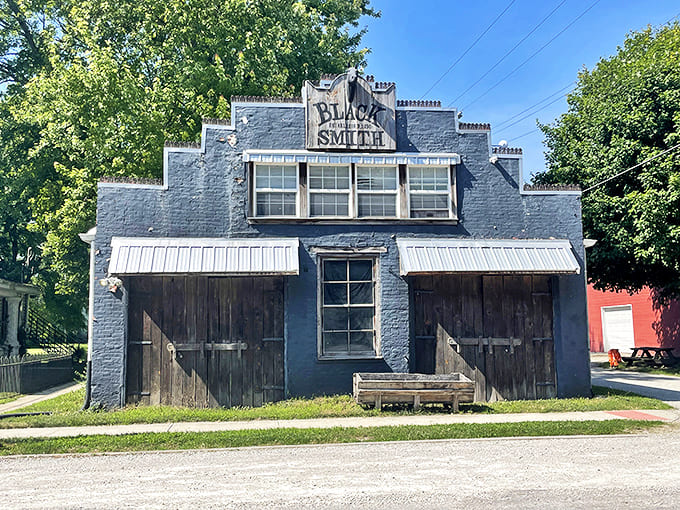 This blue blacksmith shop stands as a testament to craftsmanship from an era when things were built to last centuries, not just until the warranty expires.
