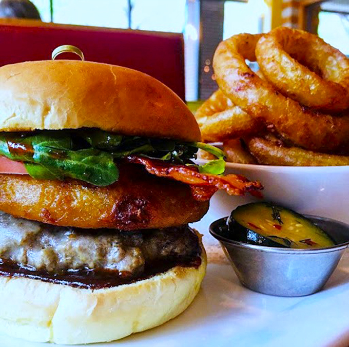 A perfectly stacked burger shares the spotlight with golden onion rings&mdash;this is diner food elevated to an art form.