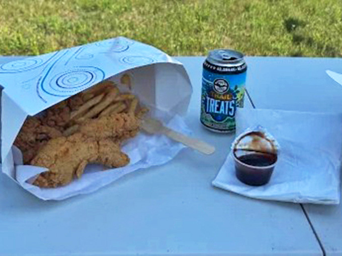 A perfect Upper Peninsula feast &ndash; golden fish, crispy fries, and a local brew, all enjoyed with Lake Superior's breeze as seasoning.