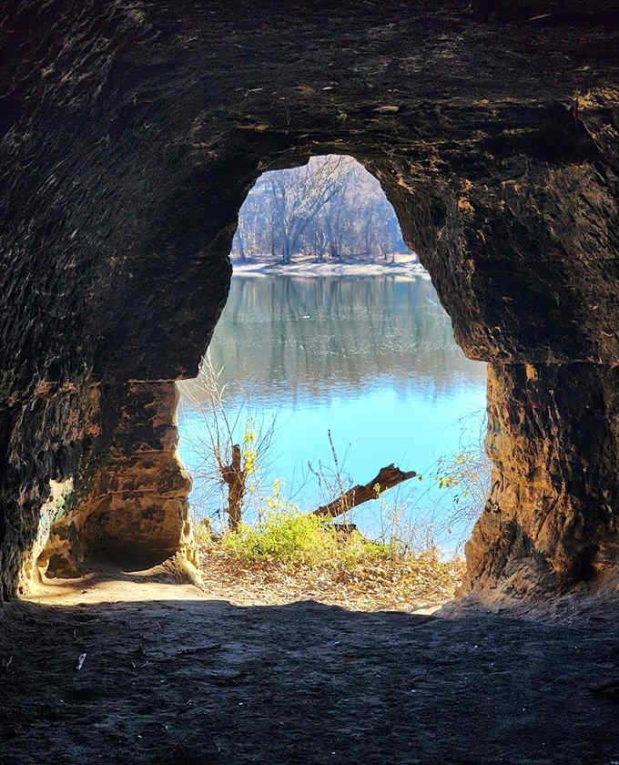 Nature frames perfection through this cave opening, where river views become living paintings worth every step of the hike.