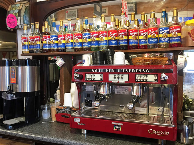 A professional espresso setup with Torani syrups lined up like flavor soldiers ready to customize your caffeine exactly right.