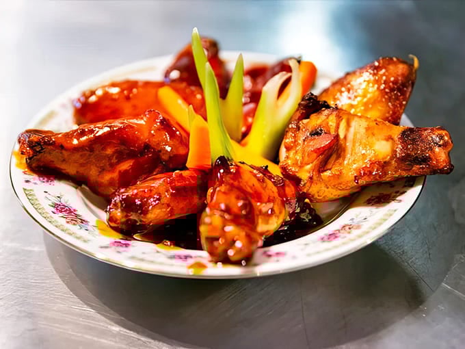 Chicken Wings: Glistening with sauce and perfectly charred, these wings weren't just smoked &ndash; they were coaxed to flavor perfection through patience and fire.