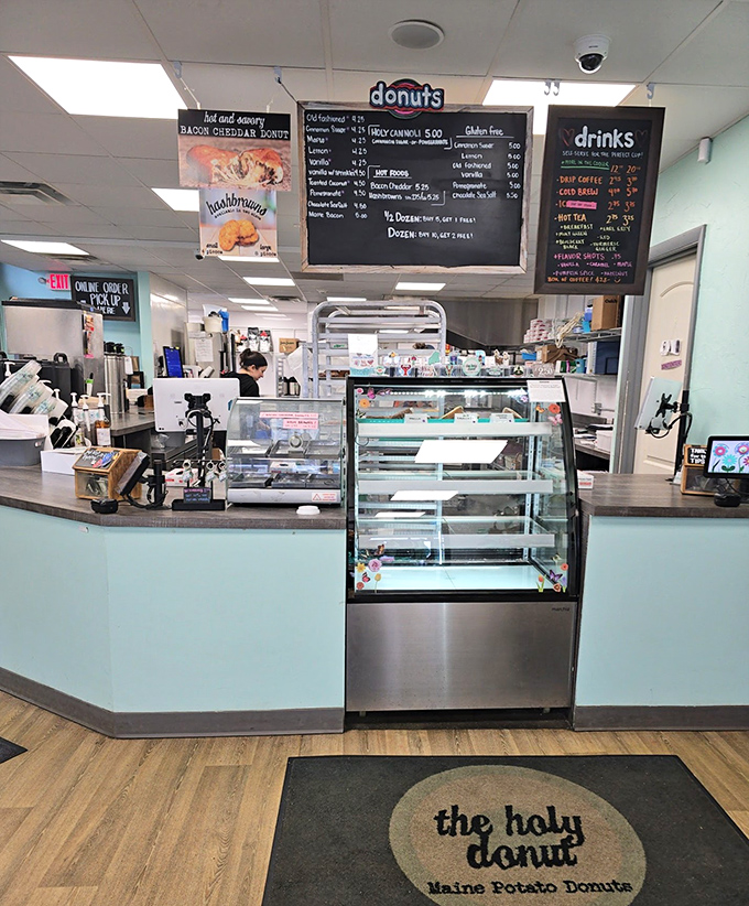 The counter area reveals the organized chaos of a beloved donut shop &ndash; where magic happens daily and diet plans go to die happily.
