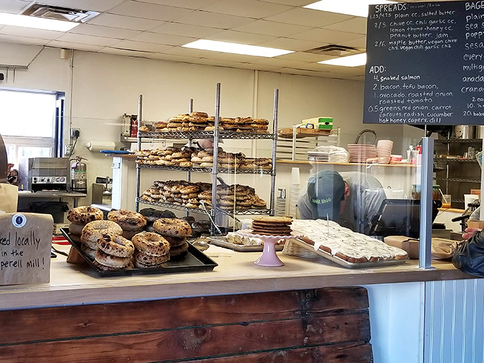 Behind this simple wooden counter, culinary magic happens daily as skilled hands transform humble ingredients into extraordinary bagels.