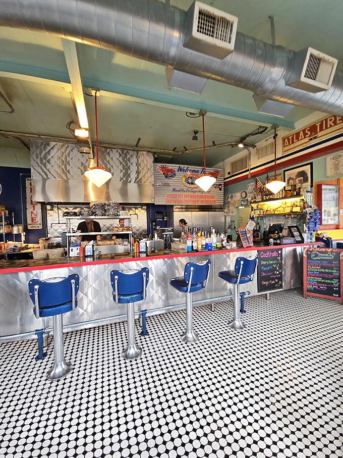 Chrome stools and quilted metal – the counter offers front-row seats to the culinary theater happening just behind it.