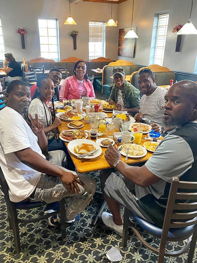 Happy diners gathered around a table loaded with breakfast prove that great food brings people together better than any social media app.