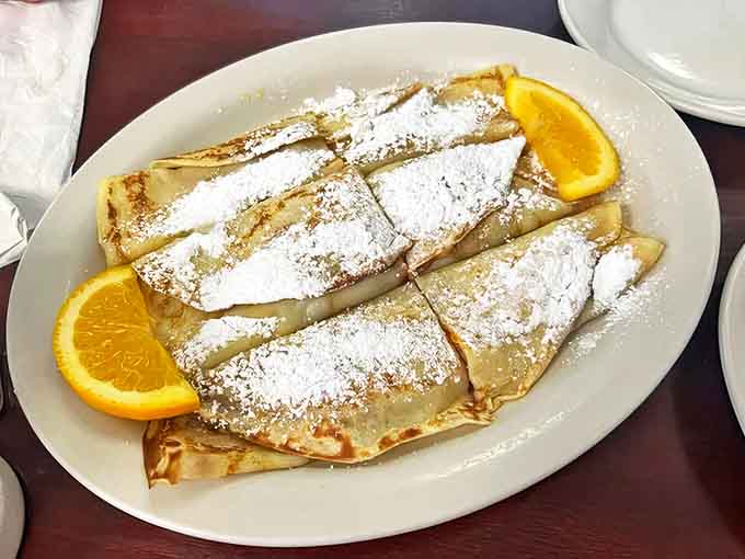These crepes aren't just dessert, they're edible love letters dusted with powdered sugar and served with a side of nostalgia.