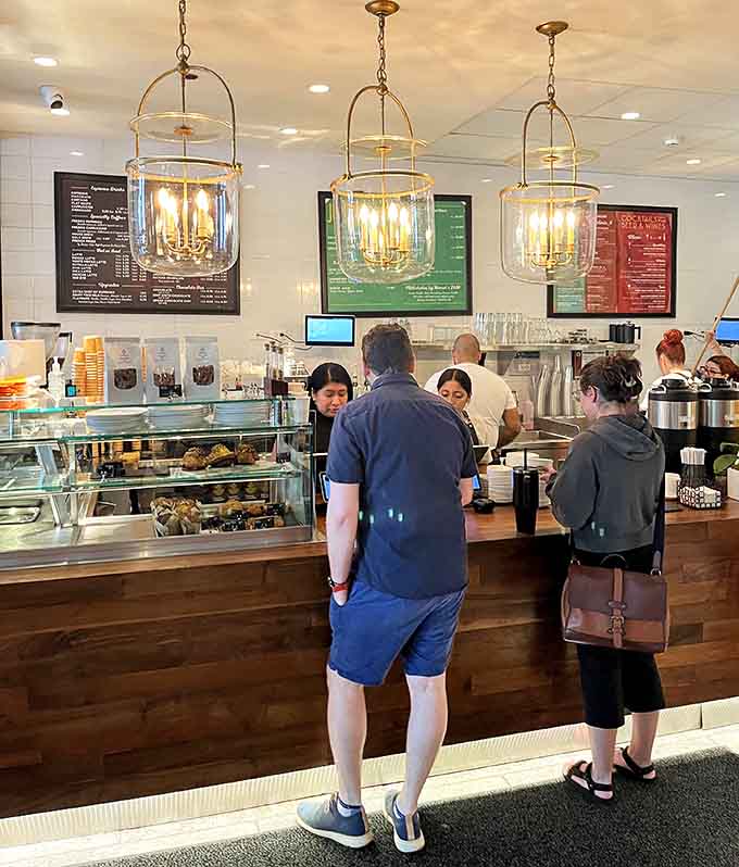 The counter area gleams with promise, where skilled baristas craft drinks and assemble sandwiches that'll make you reconsider your entire breakfast routine.