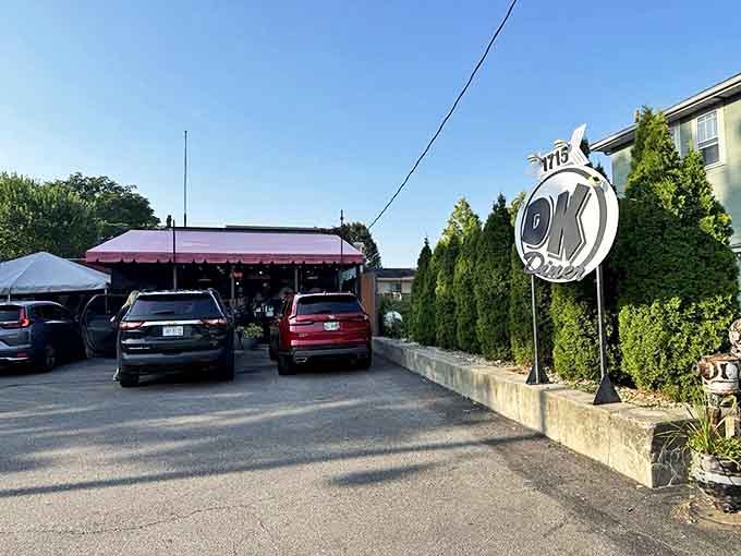 The parking lot at DK Diner, where vehicles gather like pilgrims at a breakfast shrine. Each car represents someone making excellent life choices.