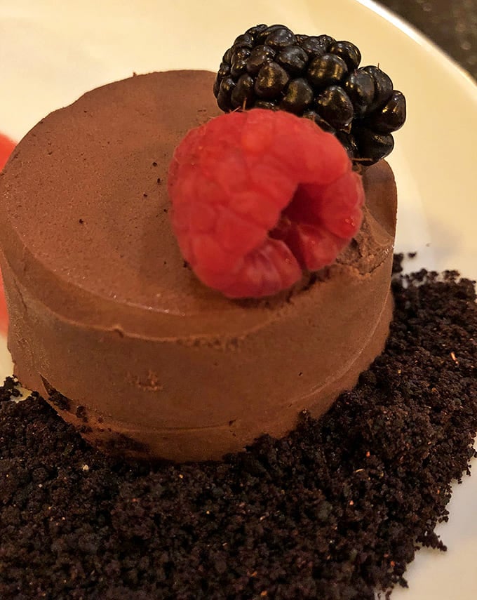 Chocolate mousse that doesn't whisper but announces its decadence, topped with fresh berries that cut through the richness perfectly.