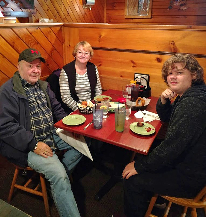 Happy diners enjoying the warm atmosphere and hearty portions that make Mac's Grill a beloved local institution.