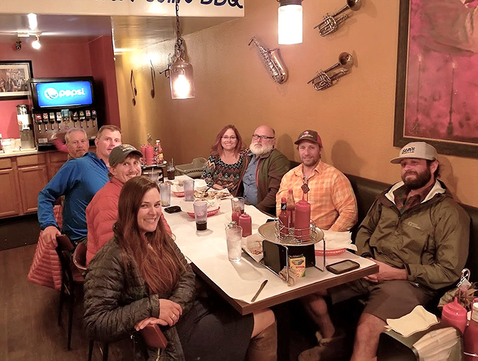 Happy diners gathered around a table at Satchmo's—proof that good food brings people together better than anything else on earth.