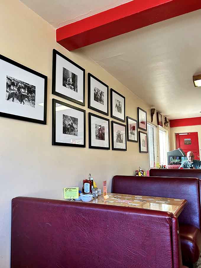 Burgundy booths and vintage photos create the perfect backdrop for your breakfast adventures.
