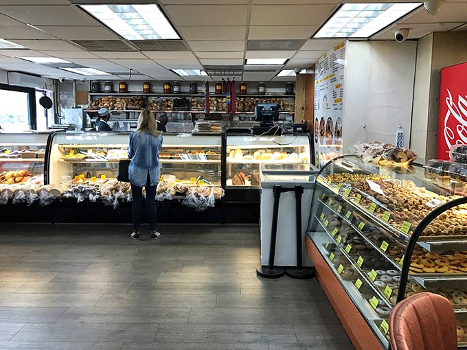 A glass-enclosed treasure chest of temptation! Fresh-baked goods beckon with the siren song of carbohydrate perfection.