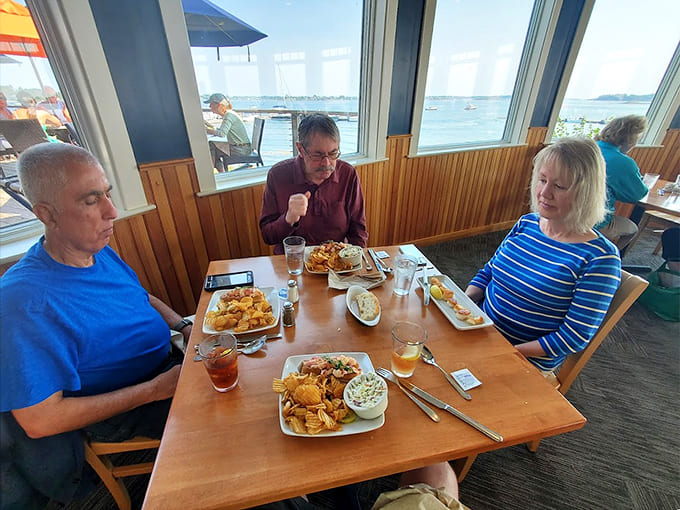Happy diners enjoying their meals with Casco Bay as their backdrop perfectly captures the relaxed, satisfying atmosphere that makes Dolphin special.
