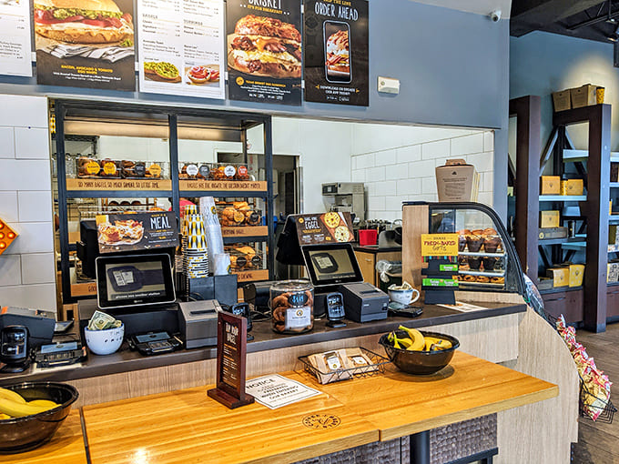 Where bagel dreams become reality &ndash; the ordering counter showcases fresh-baked goods while friendly staff stand ready to create your perfect breakfast.