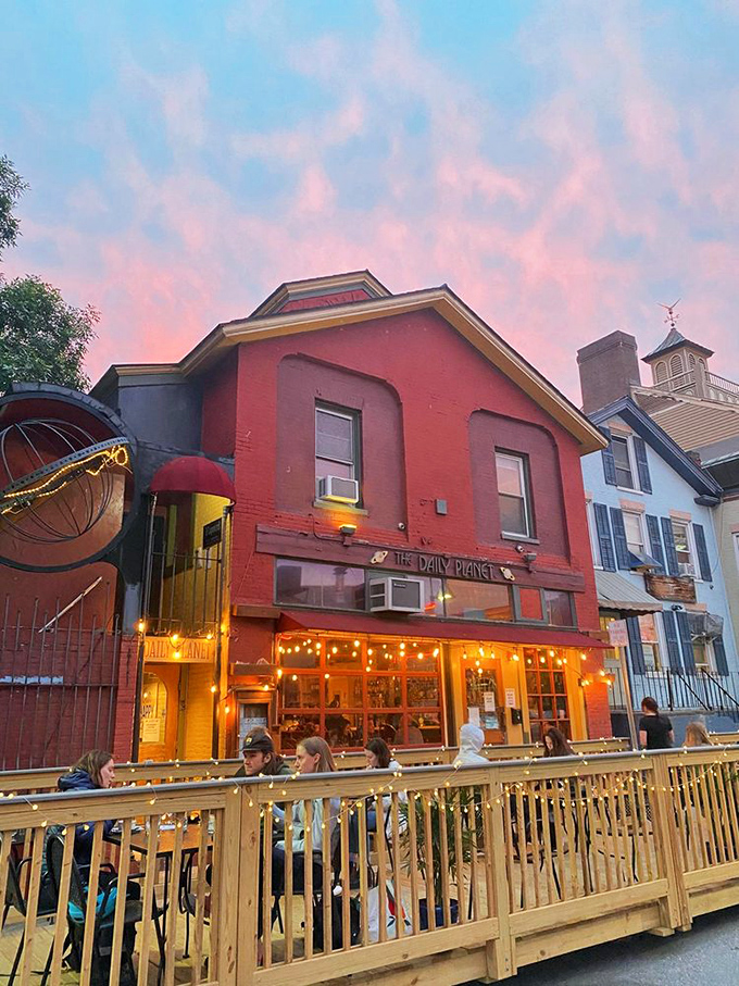 As evening falls, the patio transforms under a cotton candy sky, string lights creating a magical atmosphere where summer meals stretch lazily into night.