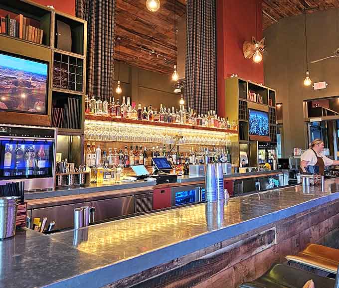 The bar area gleams with possibilities, from craft cocktails to local beers, all served in a space that feels both sophisticated and welcoming.