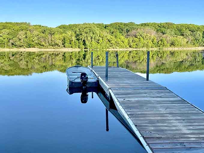 The lake becomes a mirror when the wind takes a coffee break, reflecting clouds like it's showing off for Instagram.