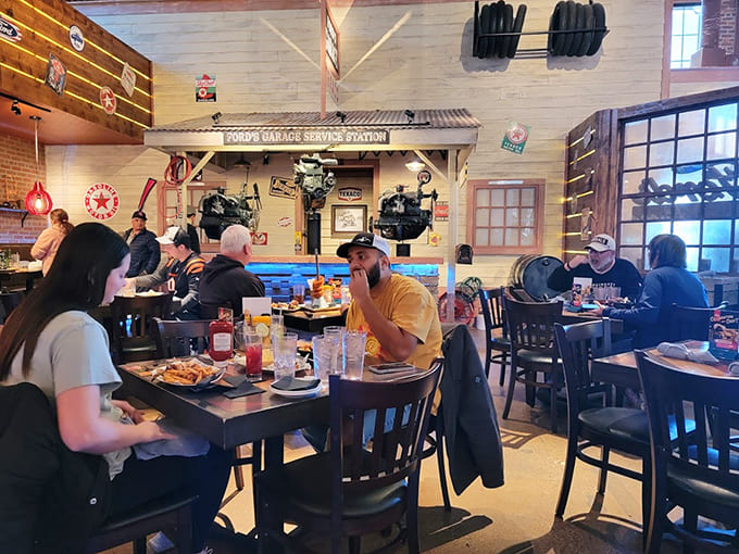 Diners enjoy their meals surrounded by automotive memorabilia and vintage charm, where the lively atmosphere makes every visit feel like a special occasion worth savoring.