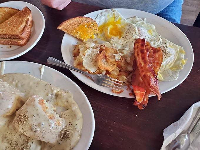 Sunny side up eggs, crispy bacon, and golden home fries. It's the holy trinity of breakfast, served with a side of joy.
