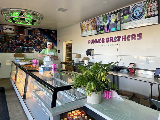 Behind the counter where magic happens and friendly staff turn your donut dreams into delicious reality.