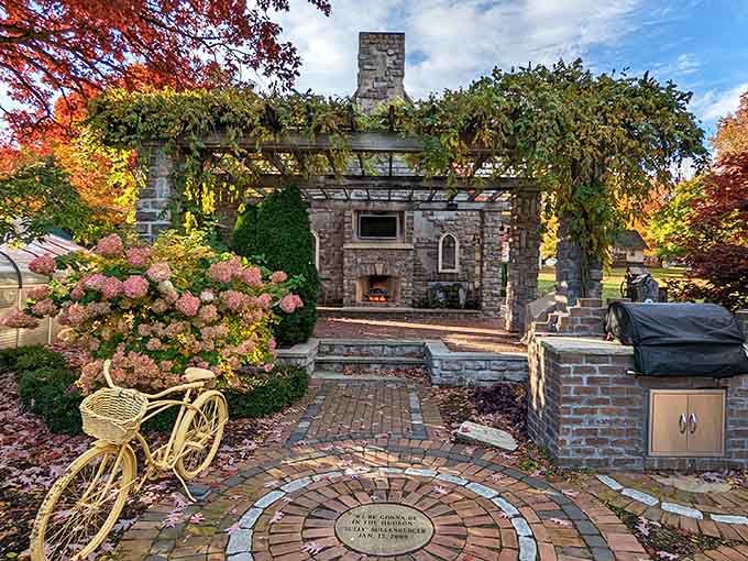 This stone structure with its outdoor fireplace and vine-covered pergola creates the perfect spot for pretending you're much fancier than you actually are.