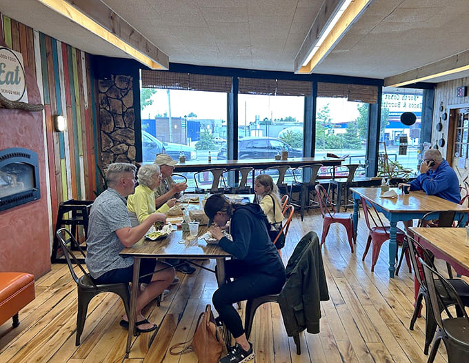 Diners enjoy their meals in the cozy interior, where strangers become friends over shared appreciation for excellent food.