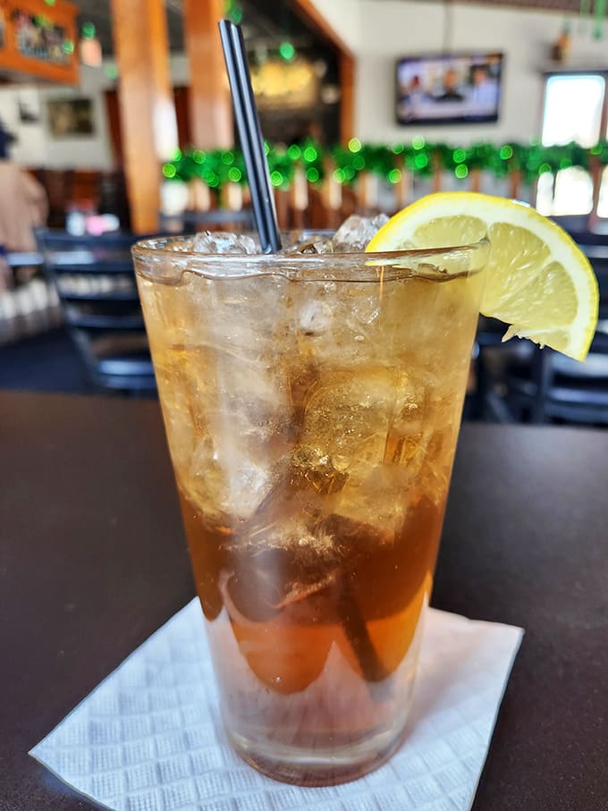 A tall, sweating glass of amber refreshment with a lemon wedge &ndash; the perfect companion to any lakeside feast on a warm afternoon.